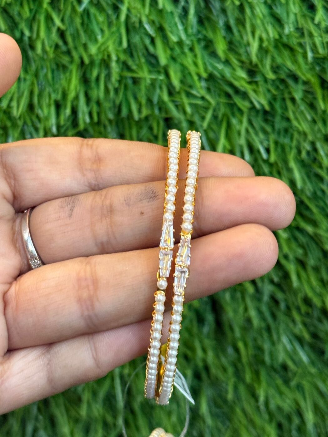 small white pearl with gold based bangle